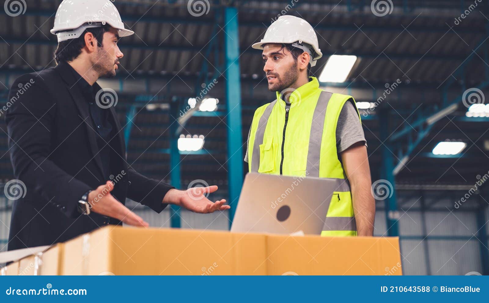 Two Factory Workers Working and Discussing Manufacturing Plan in the ...