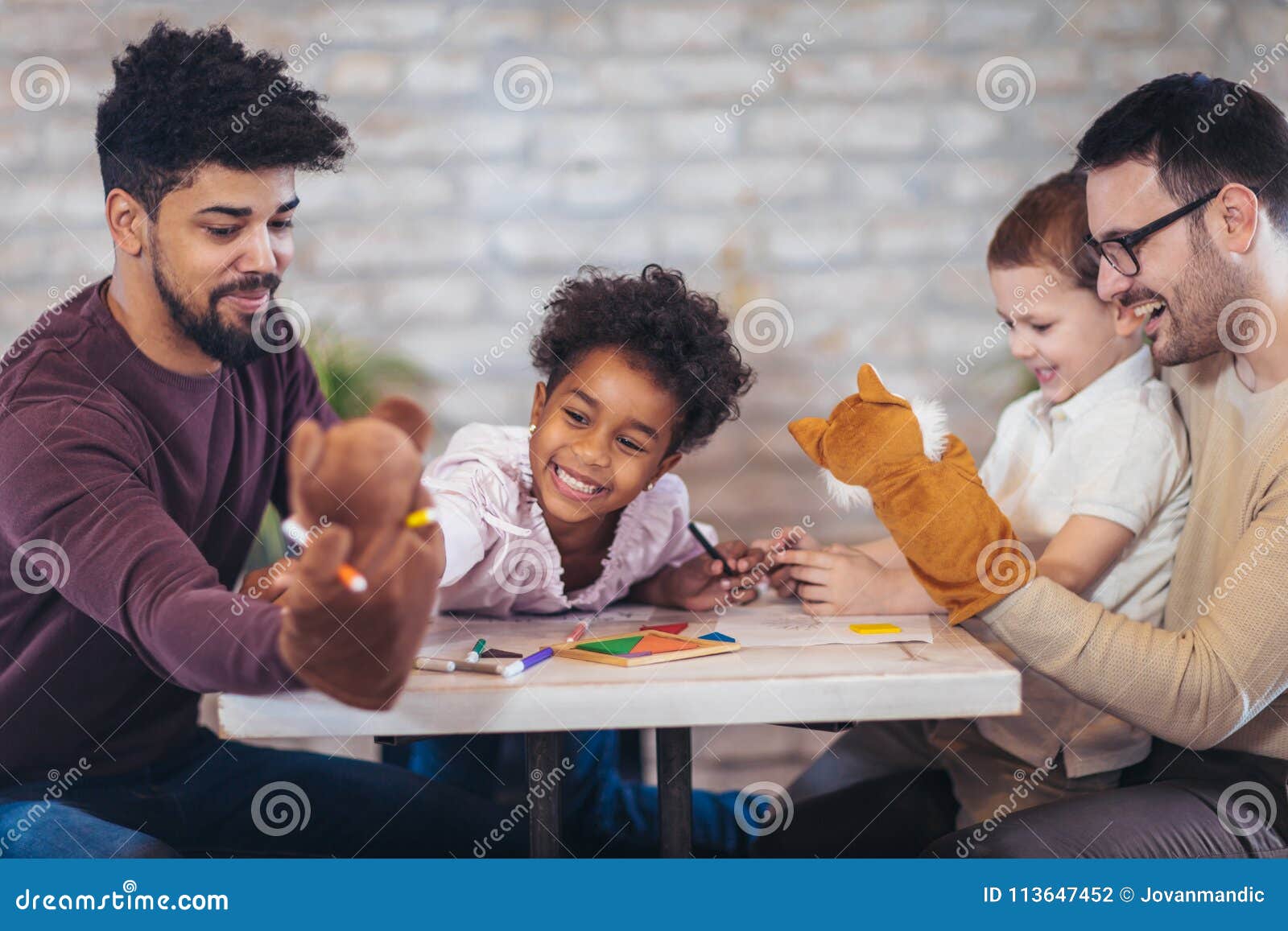 Two Fathers Play Educational Games with Their Children Stock Photo ...