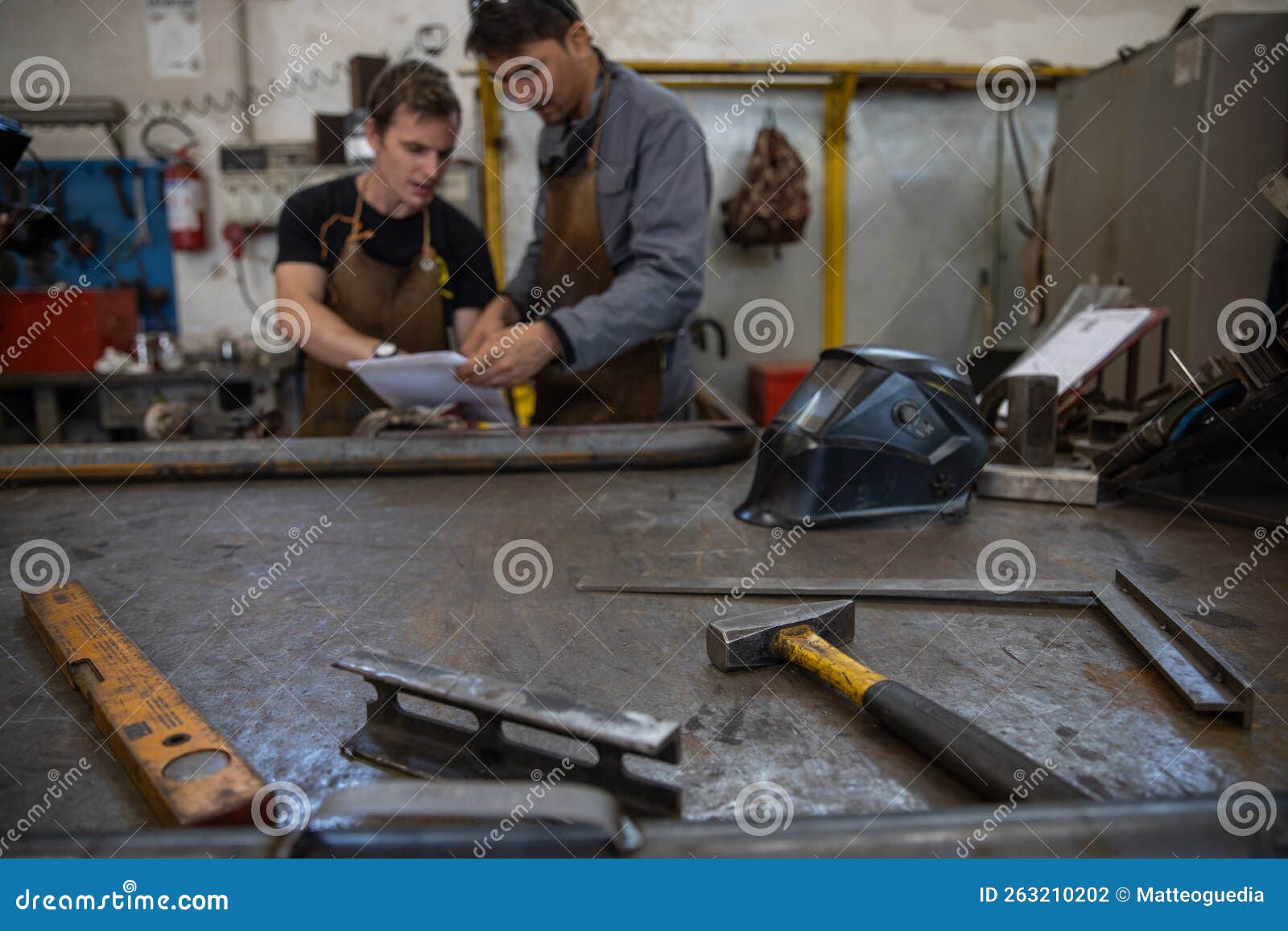 Two Fellow Workers Look at the Technical Drawings in the Factory, Focus ...
