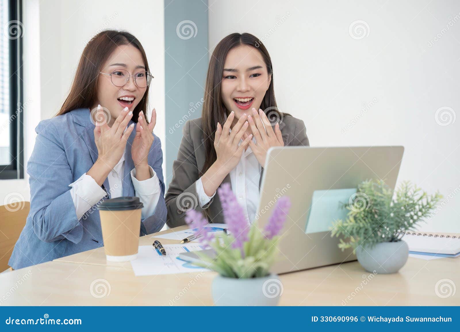 Two Female Accountant Collaborating on Financial Graphs and Data ...