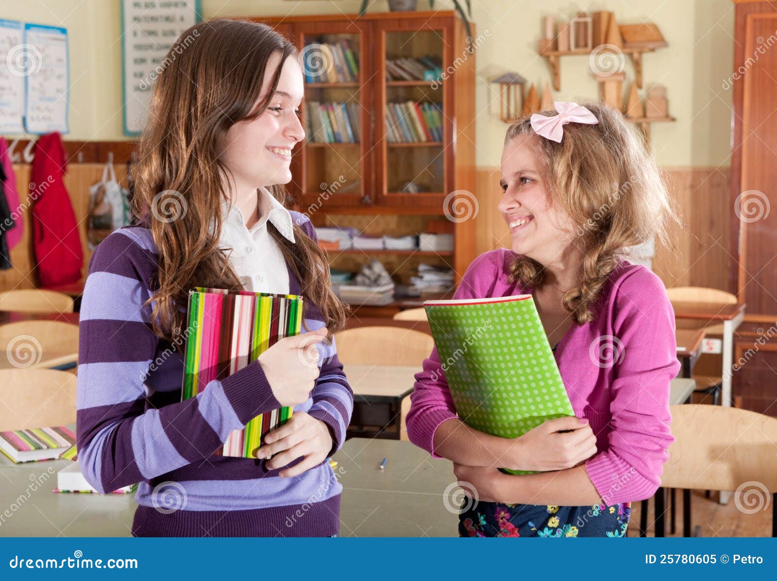 Two Female Classmates Smiling in Calssroom Stock Image - Image of ...