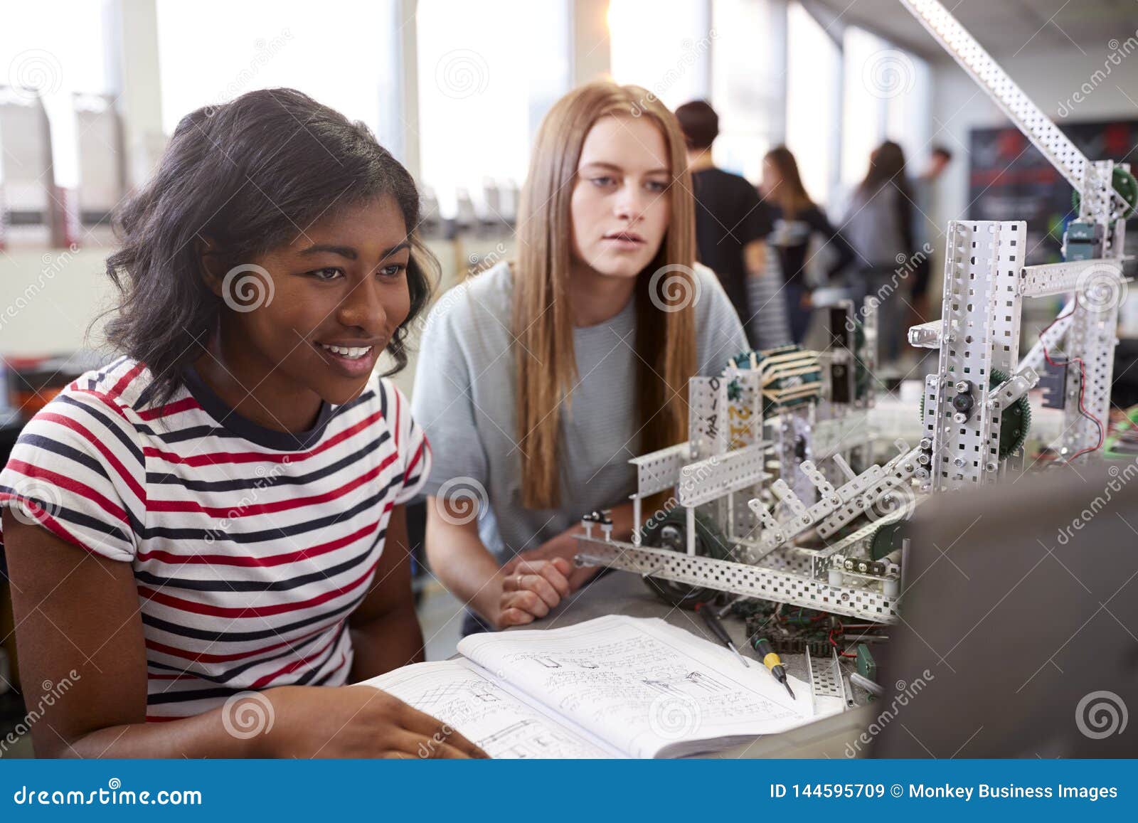 Two Female College Students Building Machine in Science Robotics or ...