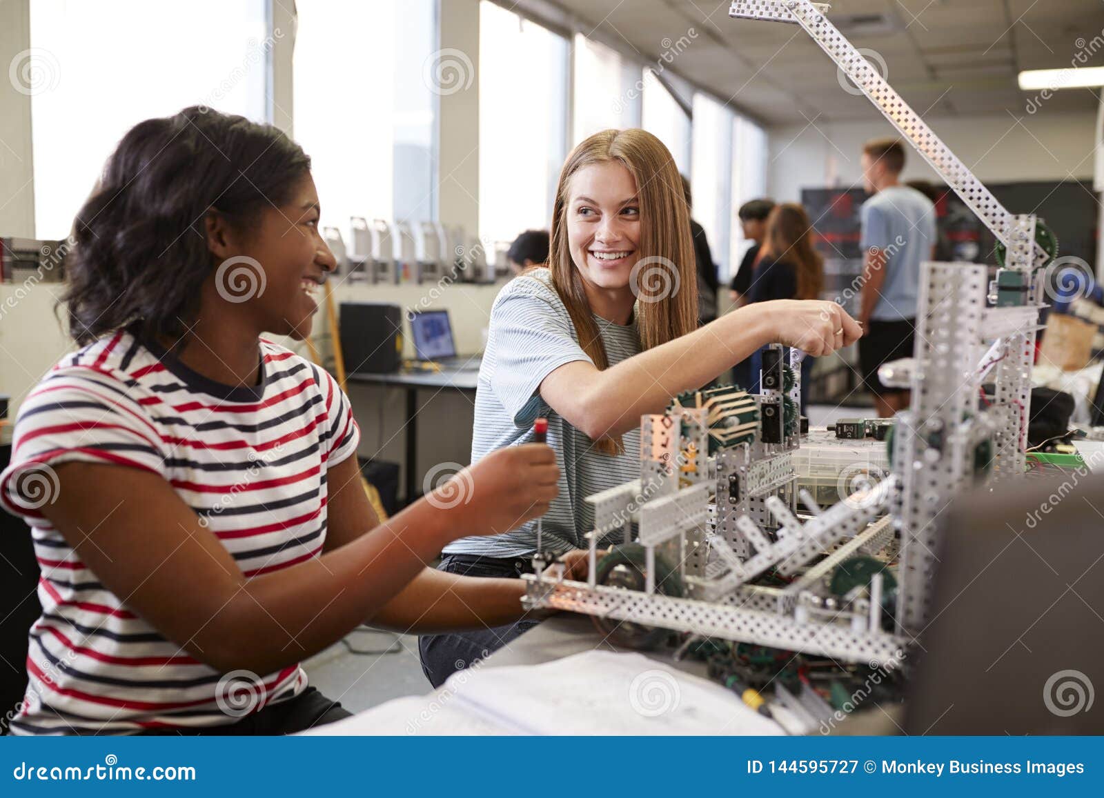 Two Female College Students Building Machine in Science Robotics or ...