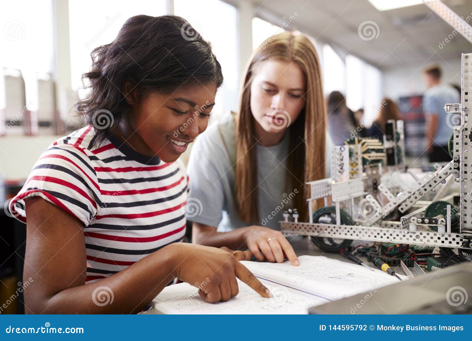 Two Female College Students Building Machine in Science Robotics or ...