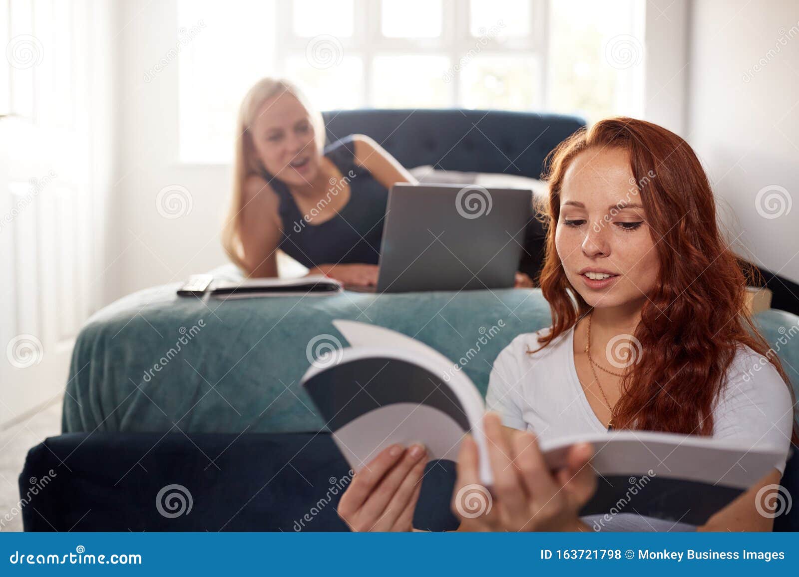 Two Female College Students in Shared House Bedroom Studying Together ...