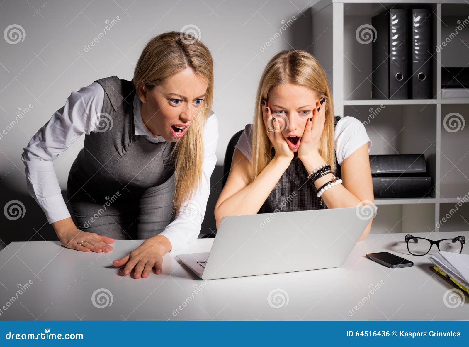 Two Female Coworkers Looking at Computer in Disbelief Stock Photo ...