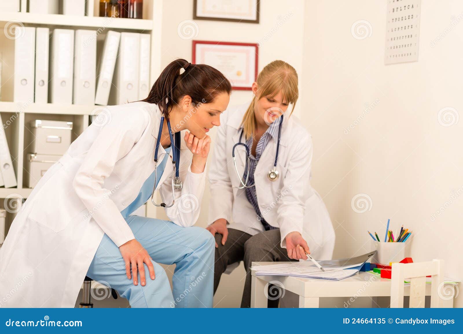 Two Female Doctor Discussing Document Stock Image - Image of occupation ...