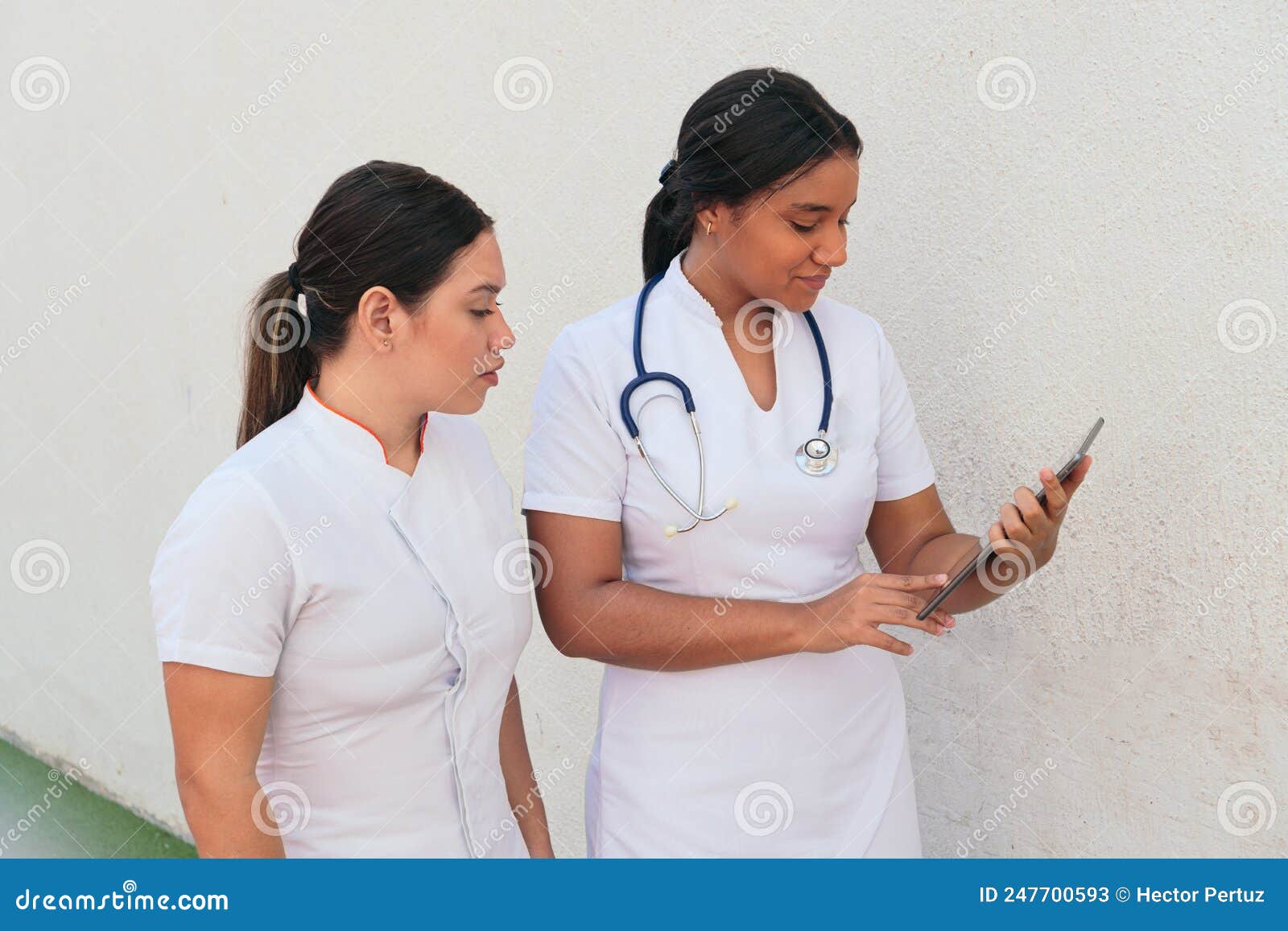 Two Female Doctors Working on a Tablet Outside the Hospital Stock Image ...