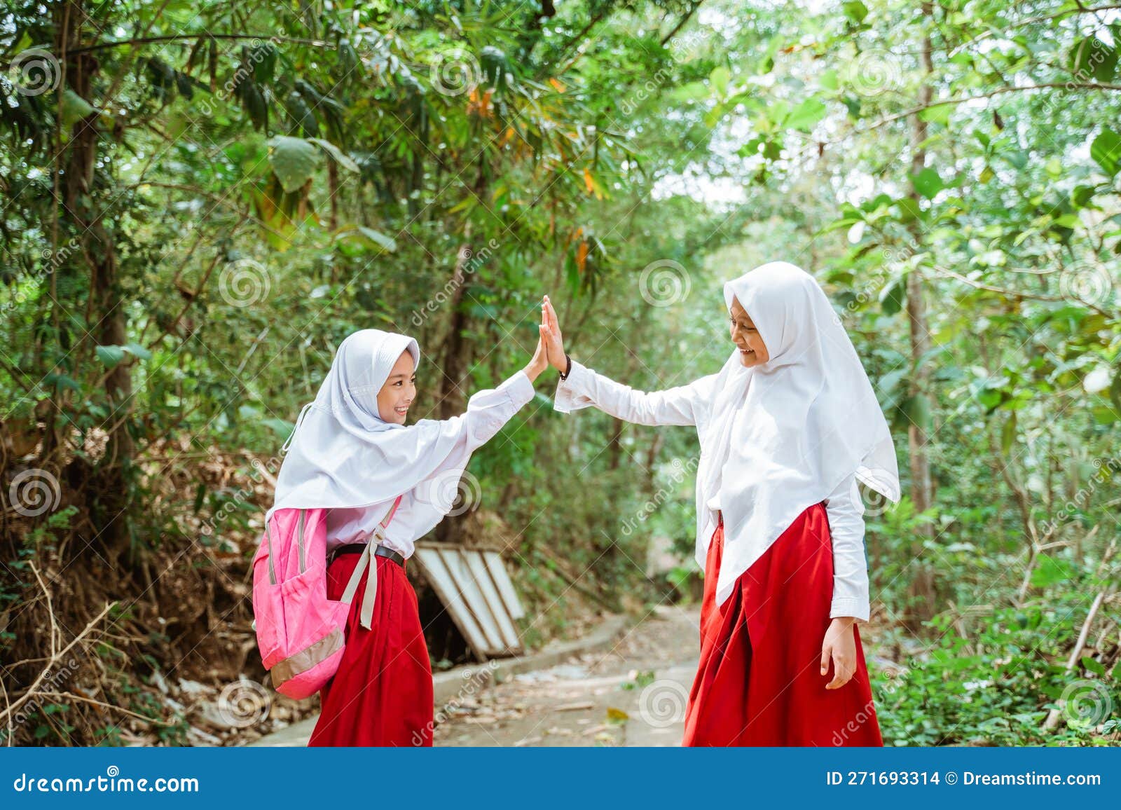 Two Female Elementary Students Doing High Five Stock Photo - Image of ...