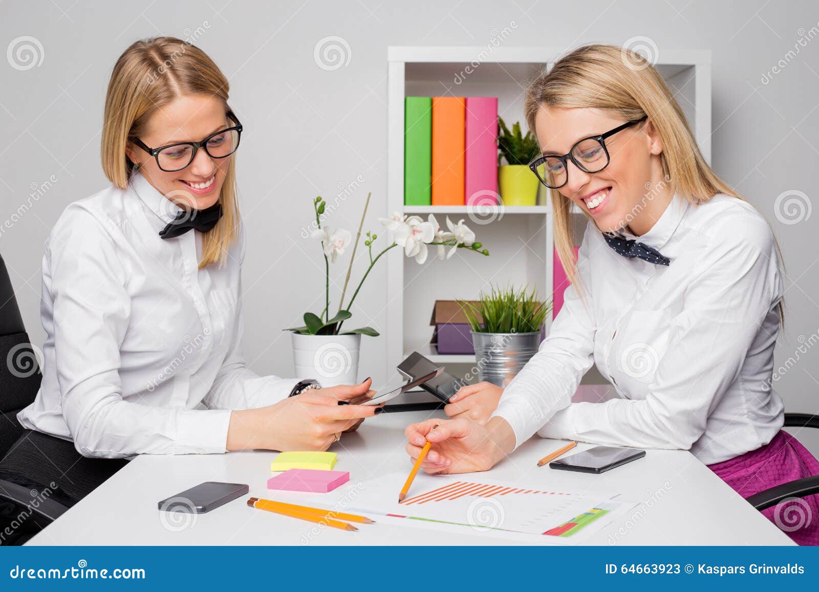 Two Female Employees Working Together Stock Image - Image of indoors ...