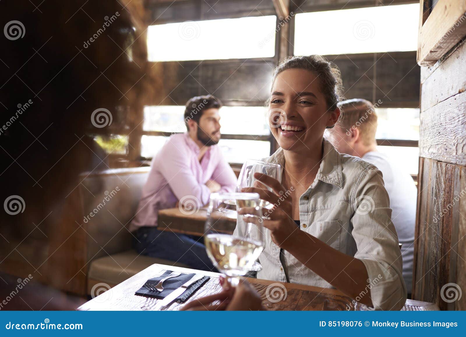 Two Female Friends Having a Drink at a Table in a Bar Stock Photo ...