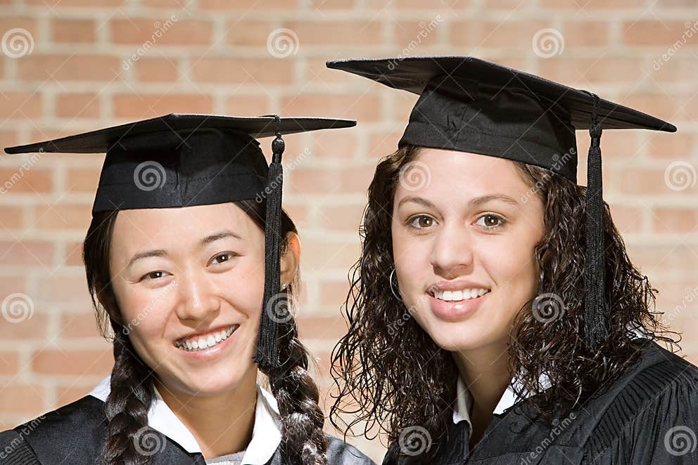 Two female graduates stock image. Image of classmates - 62809421