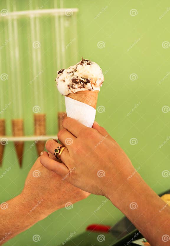 Two Female Hands Holding A Vanilla With Chocolate Ice Cream Cone Woman
