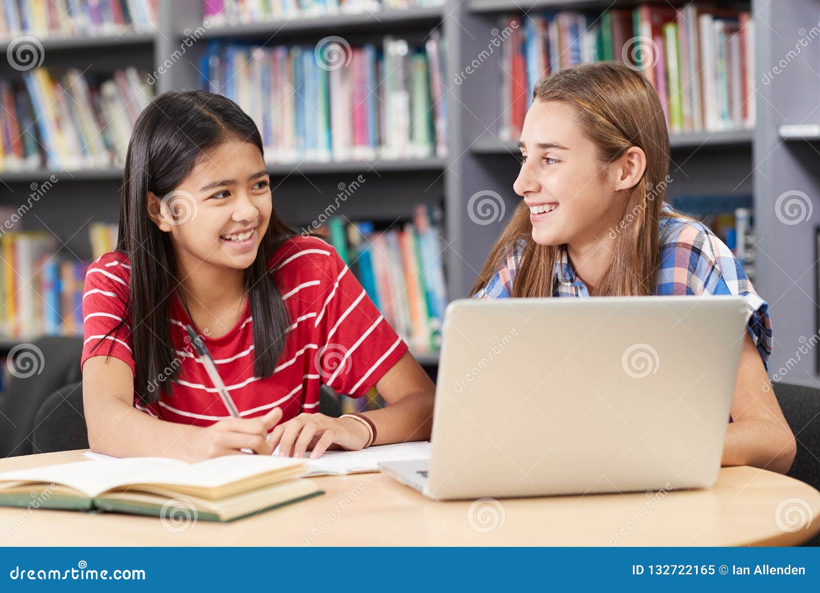 Two Female High School Students Working at Laptop in Library Stock ...