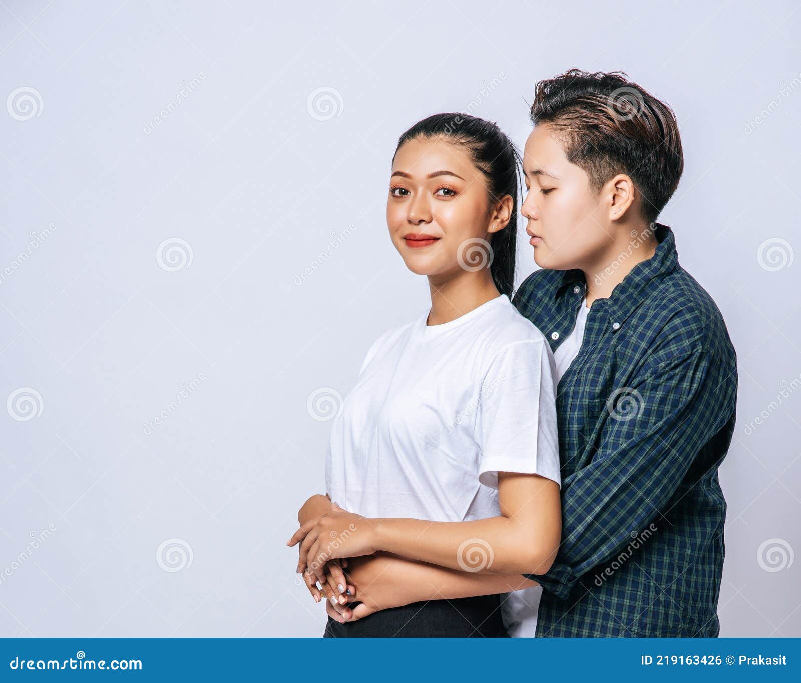 Two Female Lovers Standing and Hugging from Behind Stock Photo - Image ...