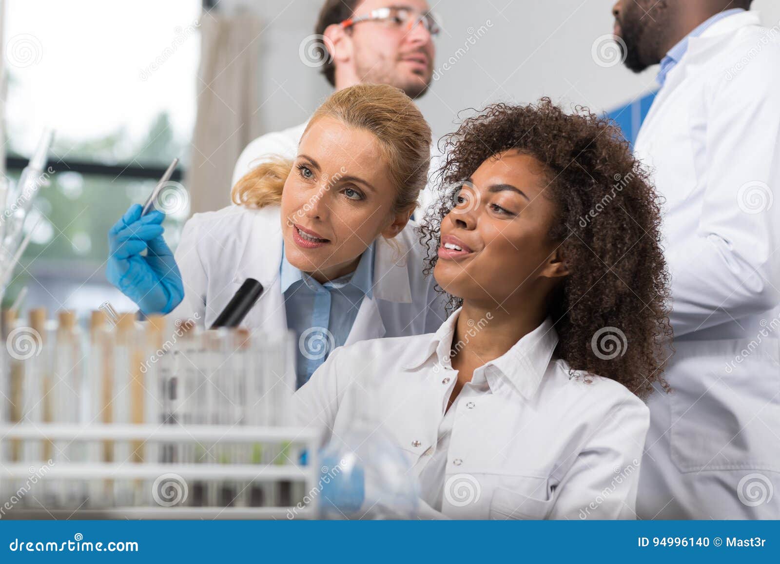 Two Female Scientist Examine Sample Working in Modern Laboratory, Group ...