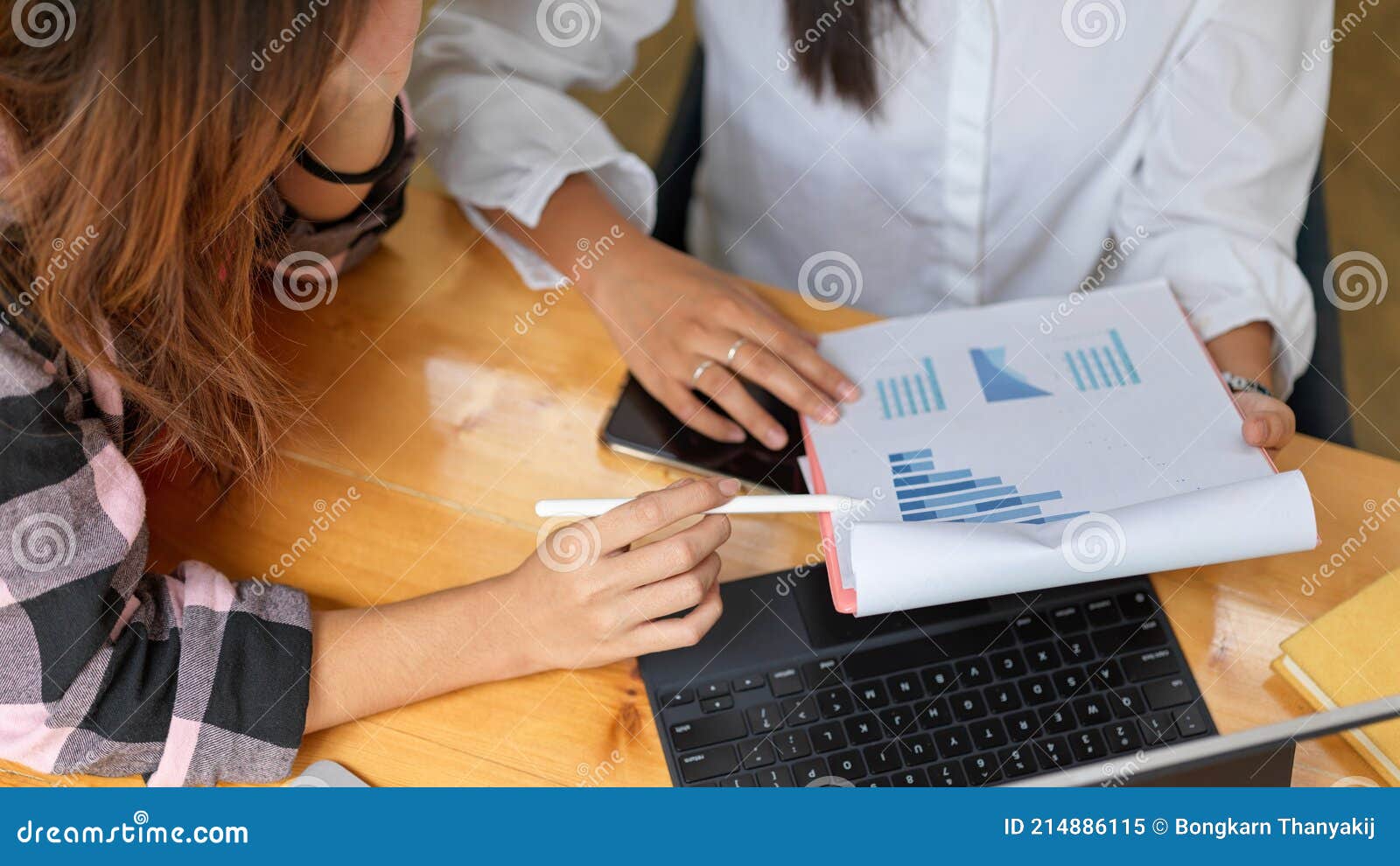 Two Female Students Doing Their Group Assignment Together with Document ...