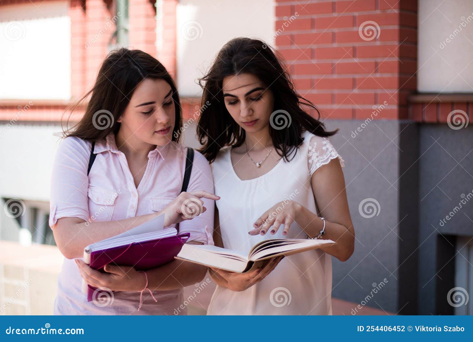 Two Female Students Preparing for Exams Together Outdoors Stock Photo ...