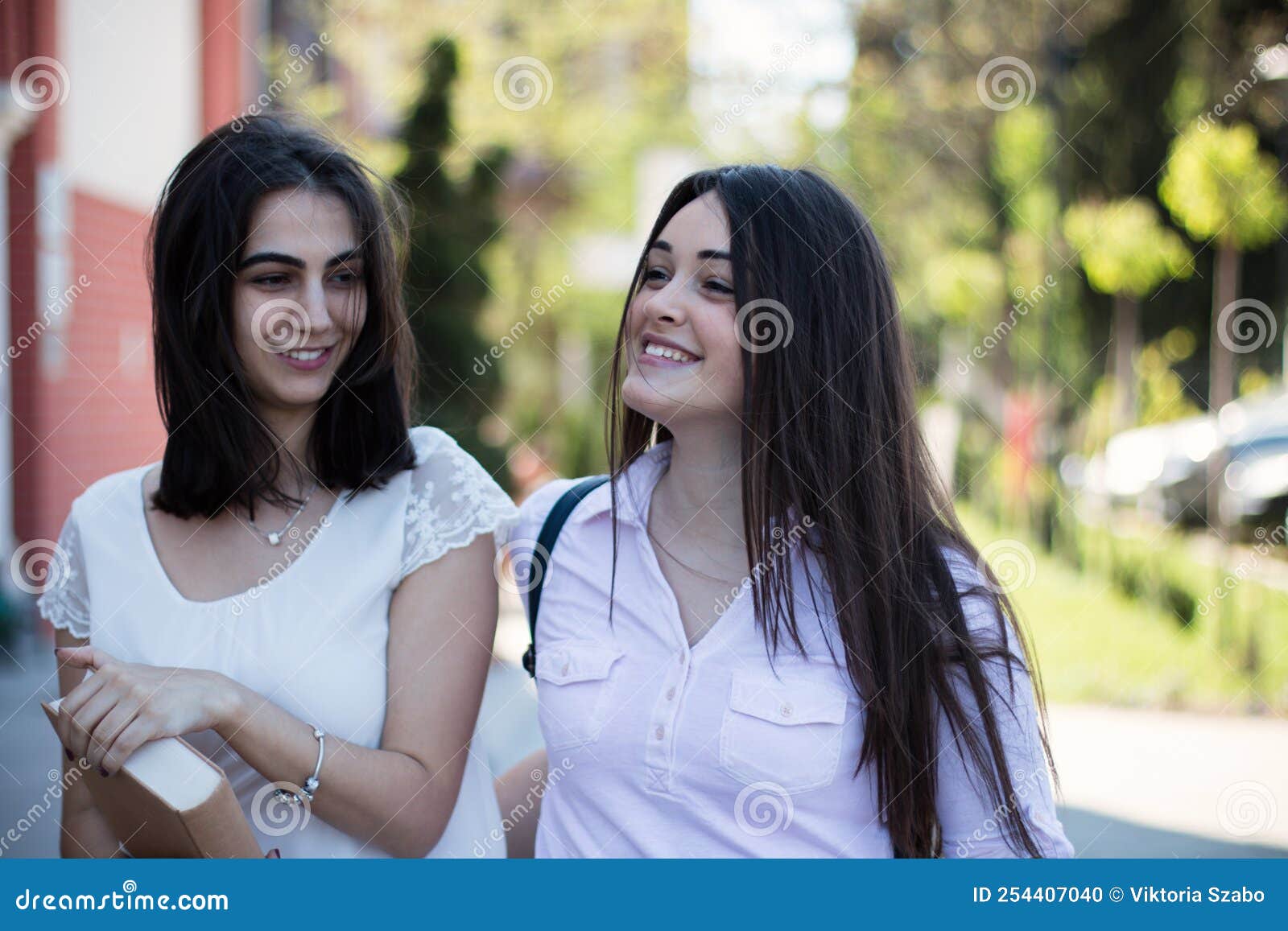 Two Female Students Walking Together on the Campus Stock Photo - Image ...