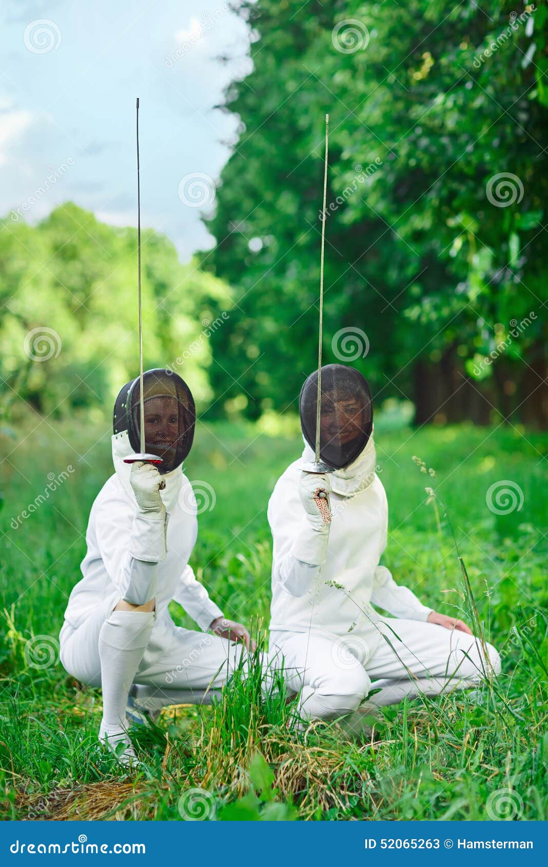 Two Fencers Women Squatting Down with Rapiers Pointing Up Stock Image ...