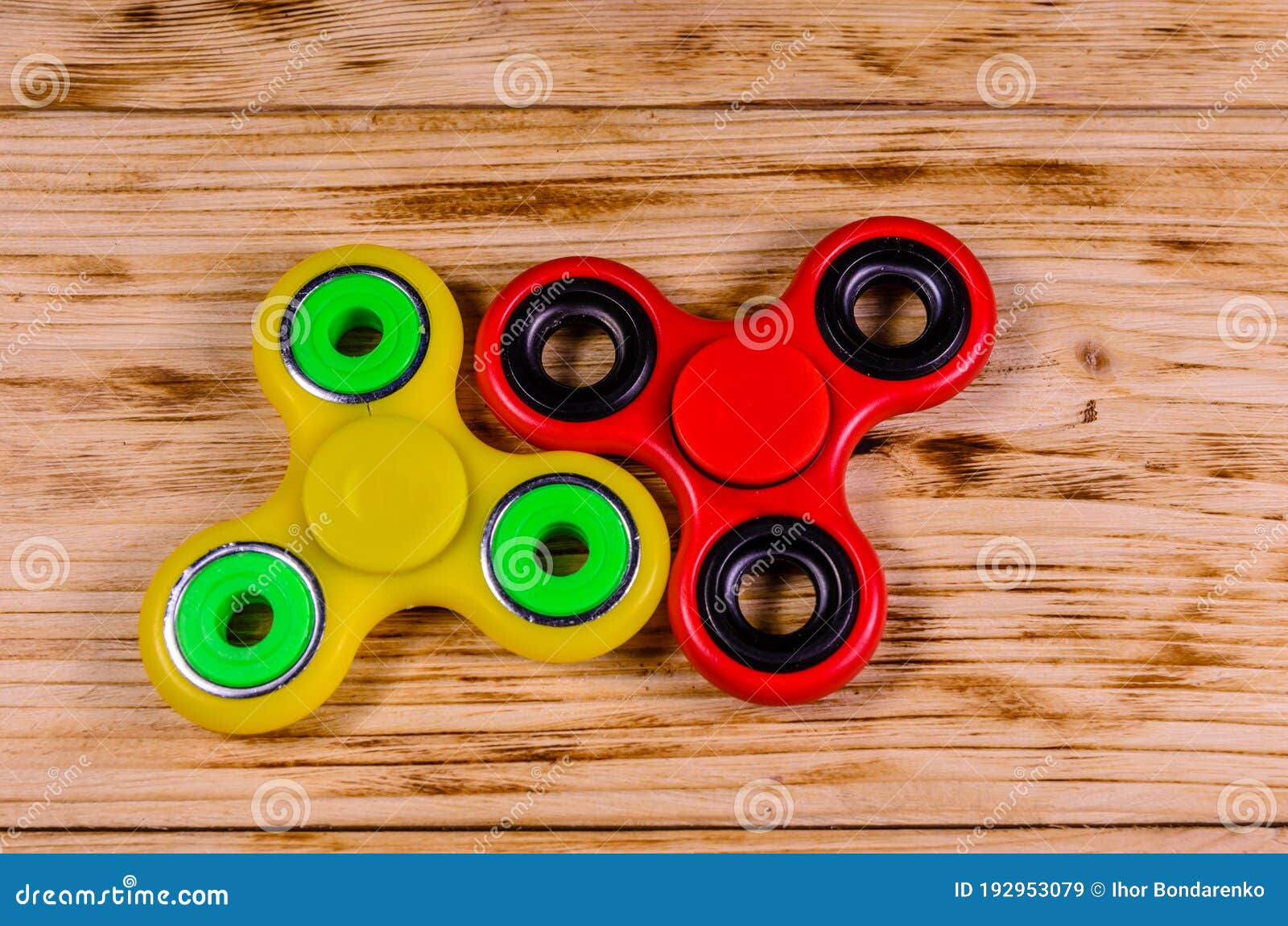 Two Fidget Spinners on Wooden Desk. Top View Stock Image - Image of ...