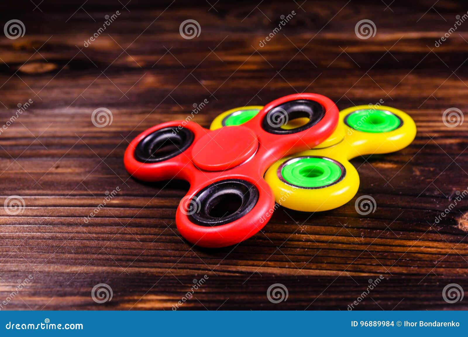 Two Fidget Spinners on Wooden Desk Stock Photo - Image of bearing ...