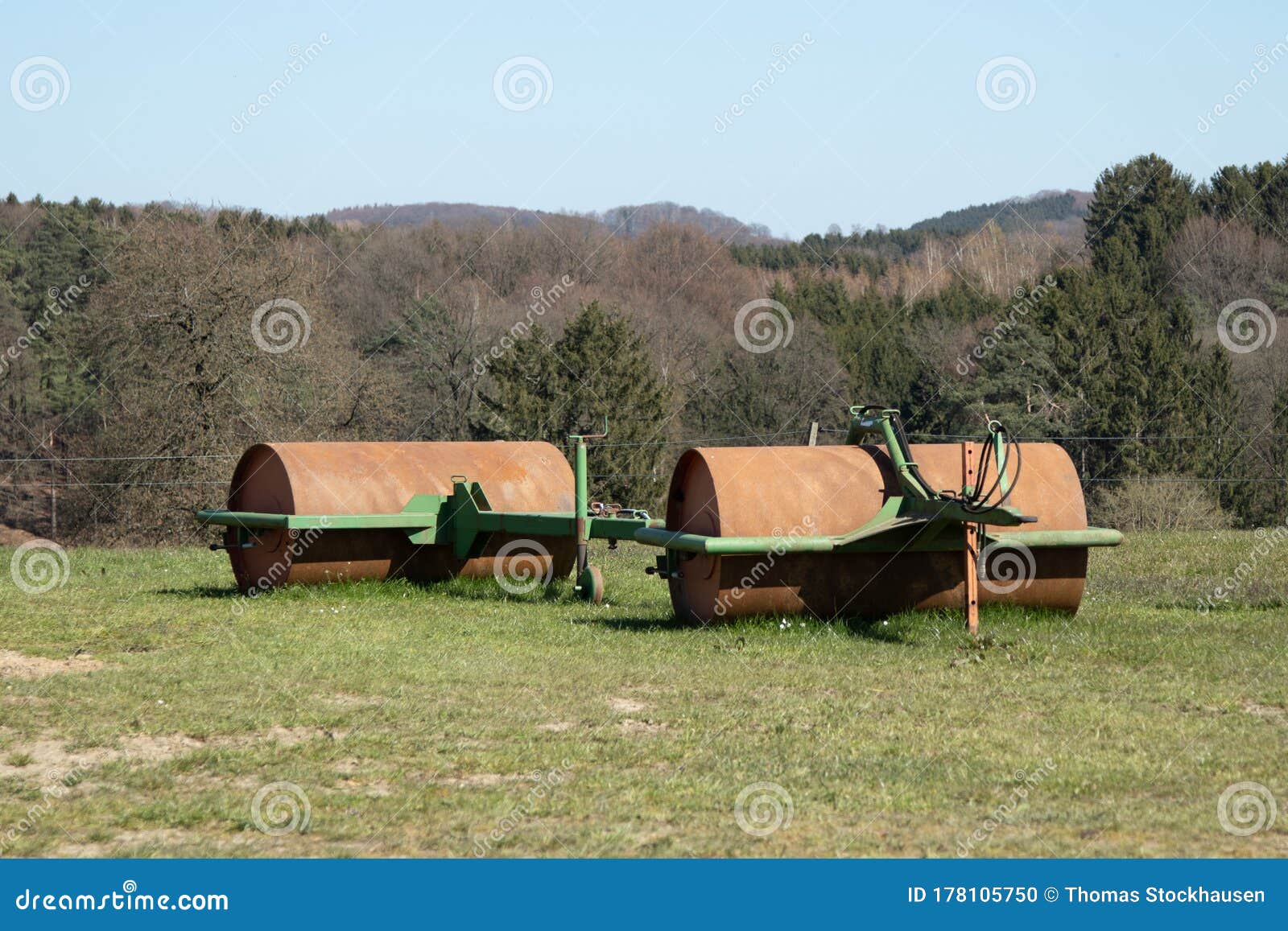 Two Field Roller on a Small Grassland, Forest and Hills in the ...