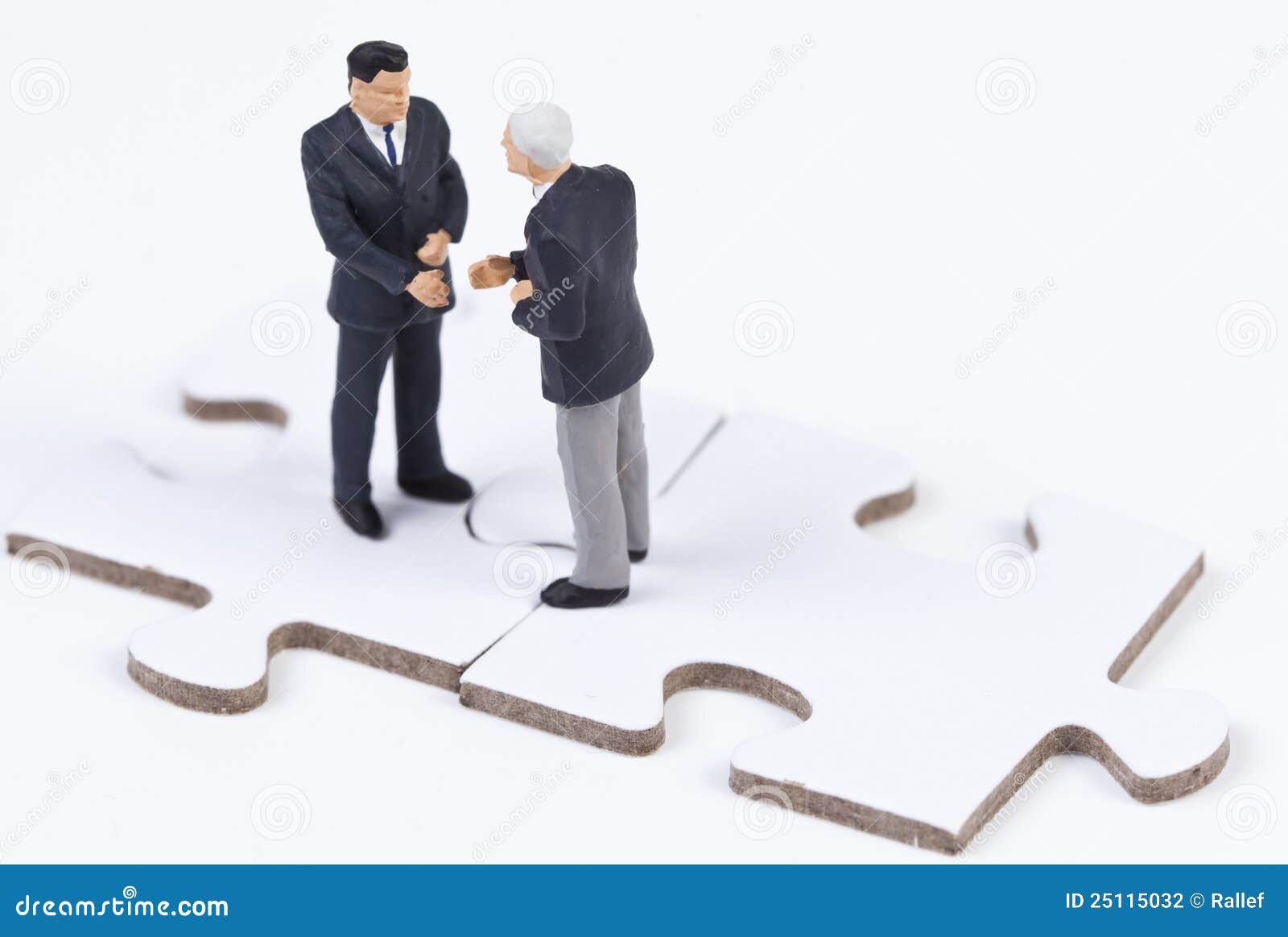 Two Figures Gives Handshake on White Puzzle Pieces Stock Photo - Image ...