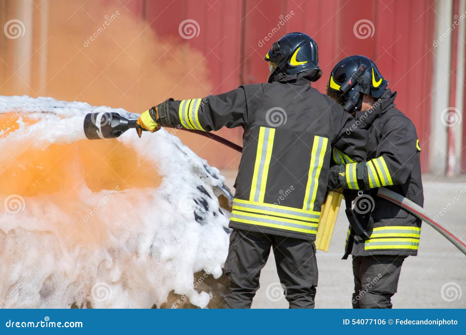 Two Firefighters in Action with Foam Stock Photo - Image of action ...