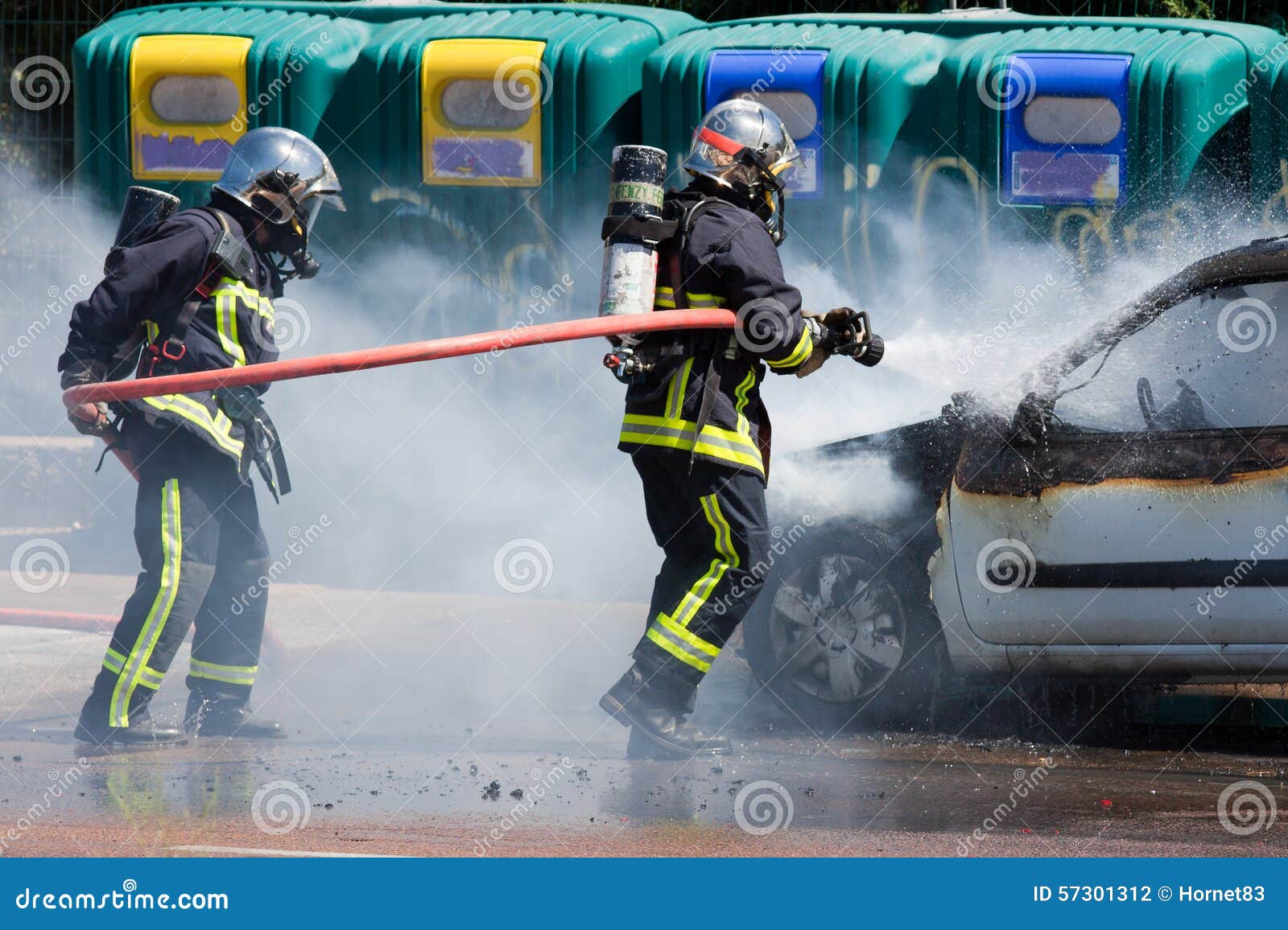 Two firefighters in action stock photo. Image of firefighters - 57301312