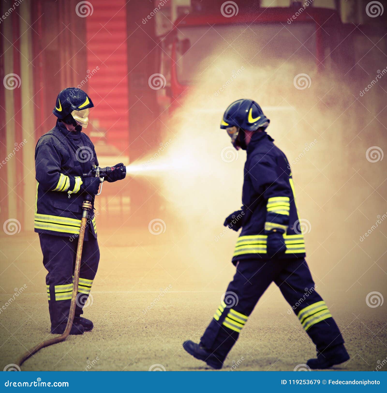 Two Firefighters during the Extinguishing of a Fire Using the Fo Stock ...