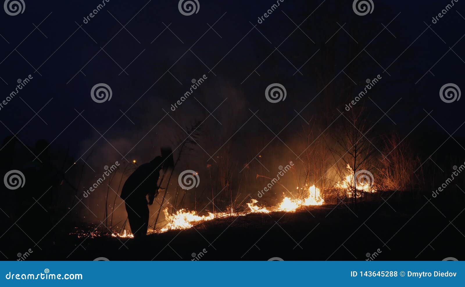 Two Firefighters with Fire Flappers Extinguish a Fire in the Forest ...