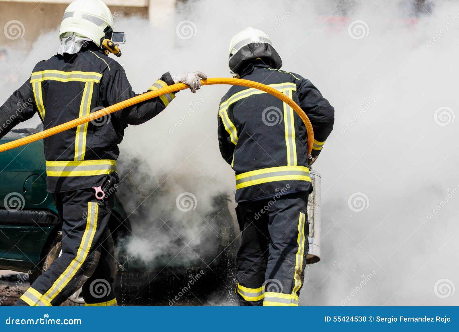 Two Firefighters Putting Out a Car Fire Stock Photo - Image of ...