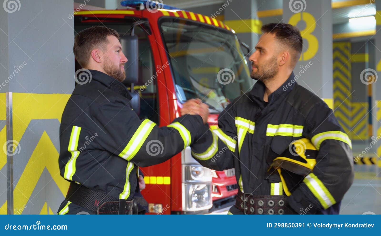 Two Firefighters Shake Hands at a Fire Station, Friendly Handshake ...