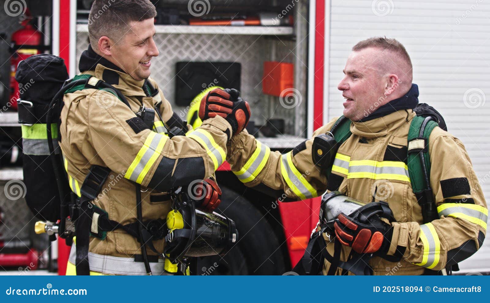 Two Firefighters Shaking Hands after Successful Fire Drill Stock Photo ...