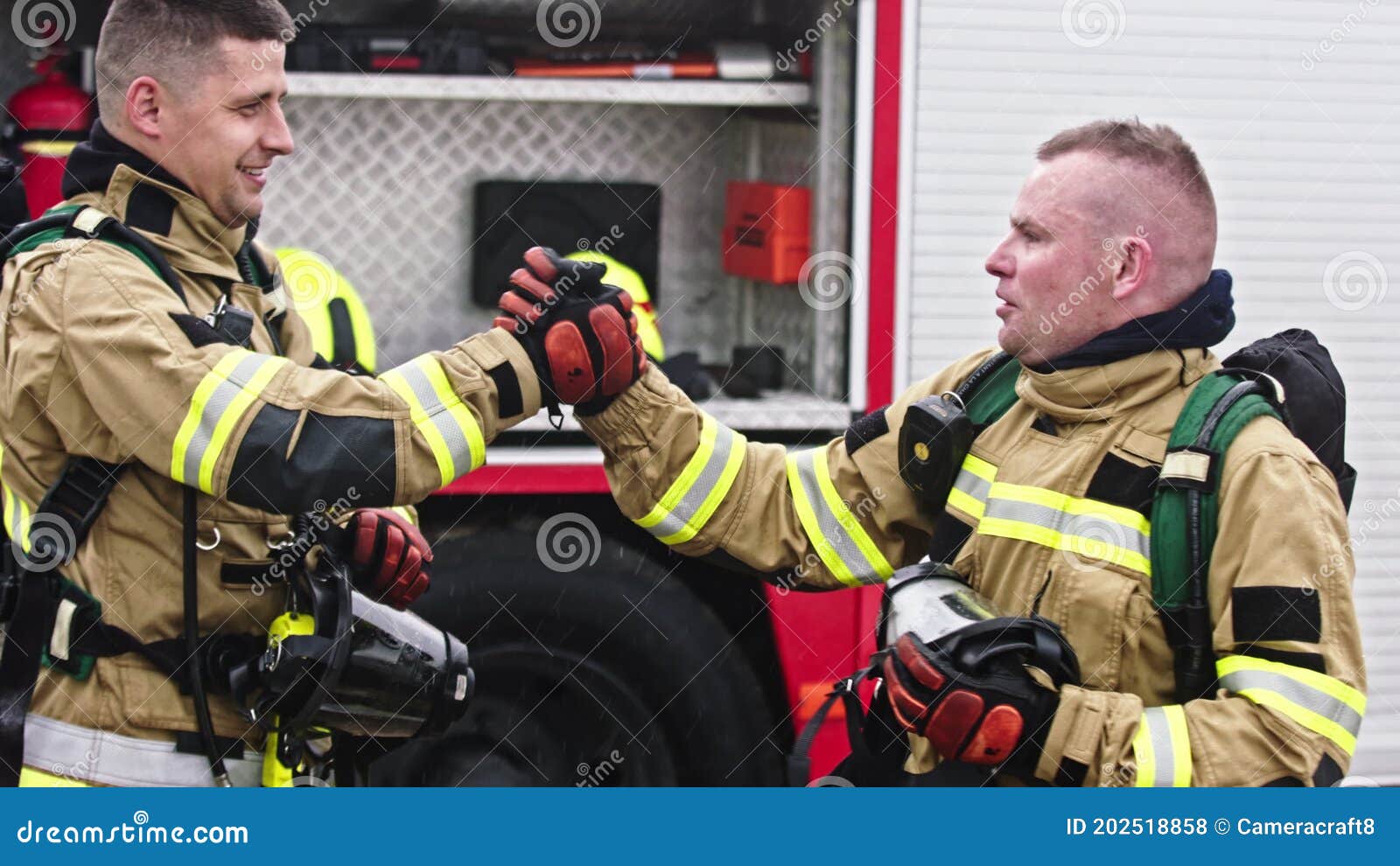 Two Firefighters Shaking Hands after Successful Fire Drill Stock ...