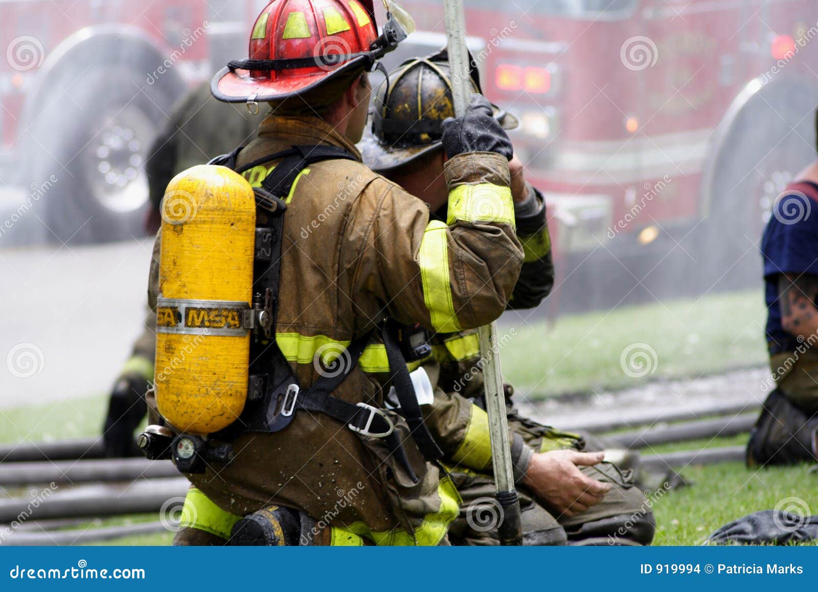 Two firemen kneeling stock photo. Image of inferno, dirty - 919994