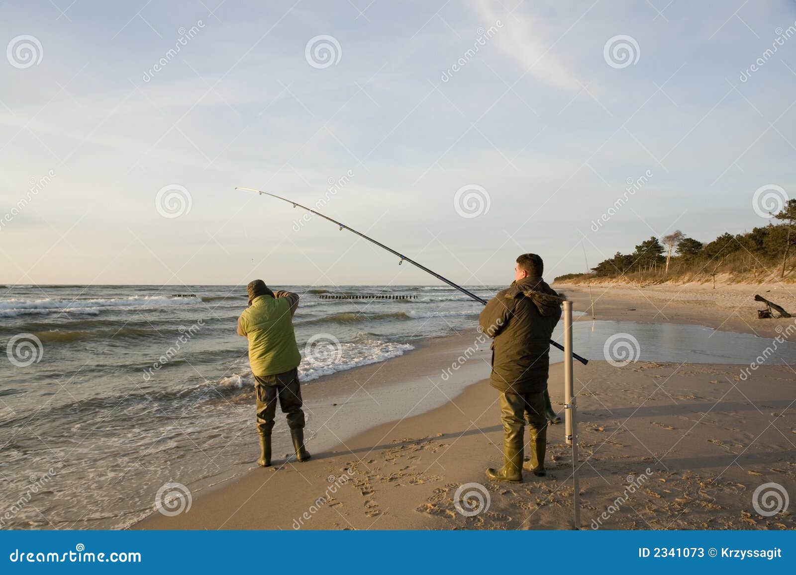 Two fishermen on beach stock image. Image of cast, sand - 2341073
