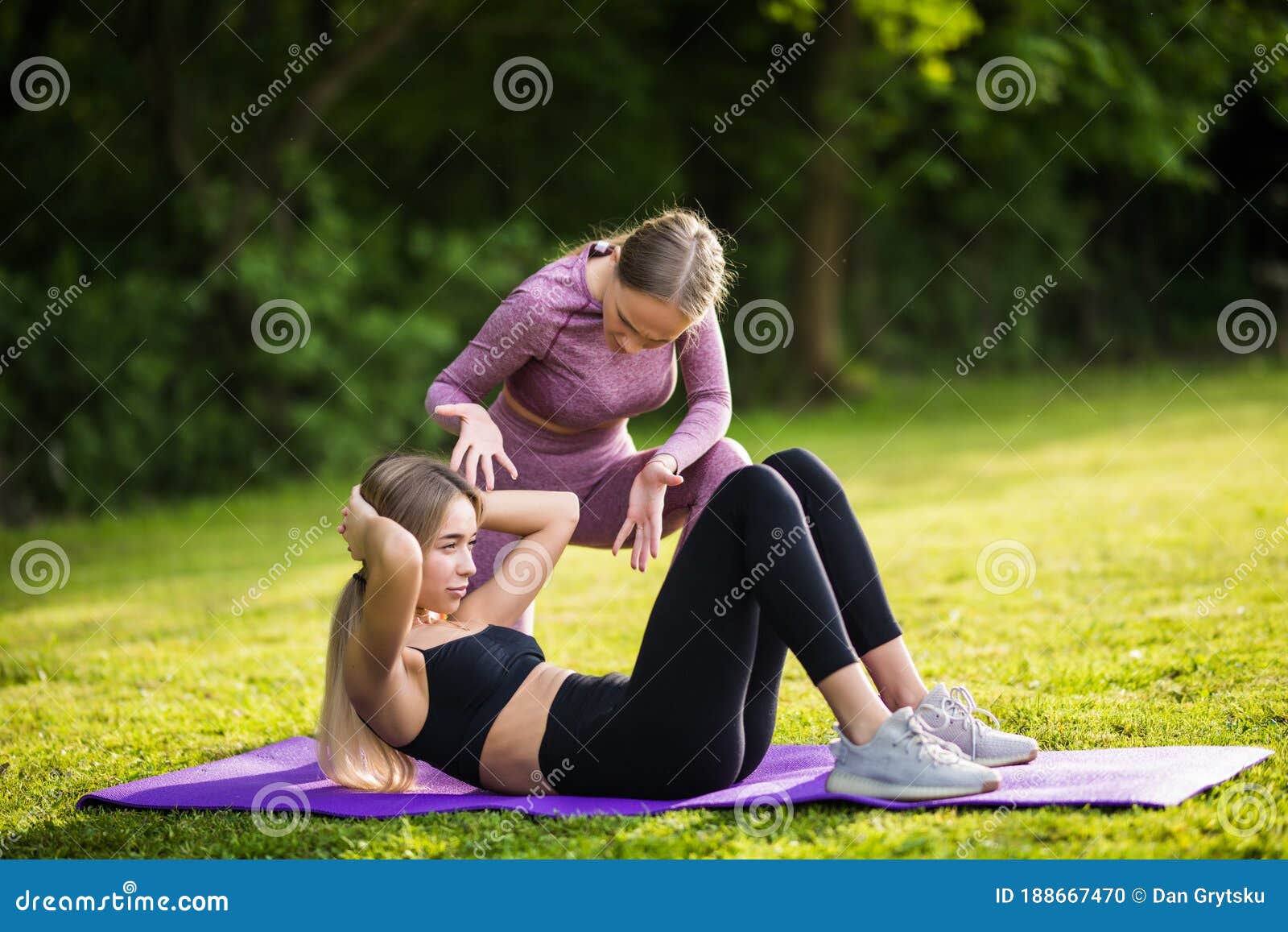 Two Fit Girlfriends Doing Partner Sit-up Exercise with High-five in ...