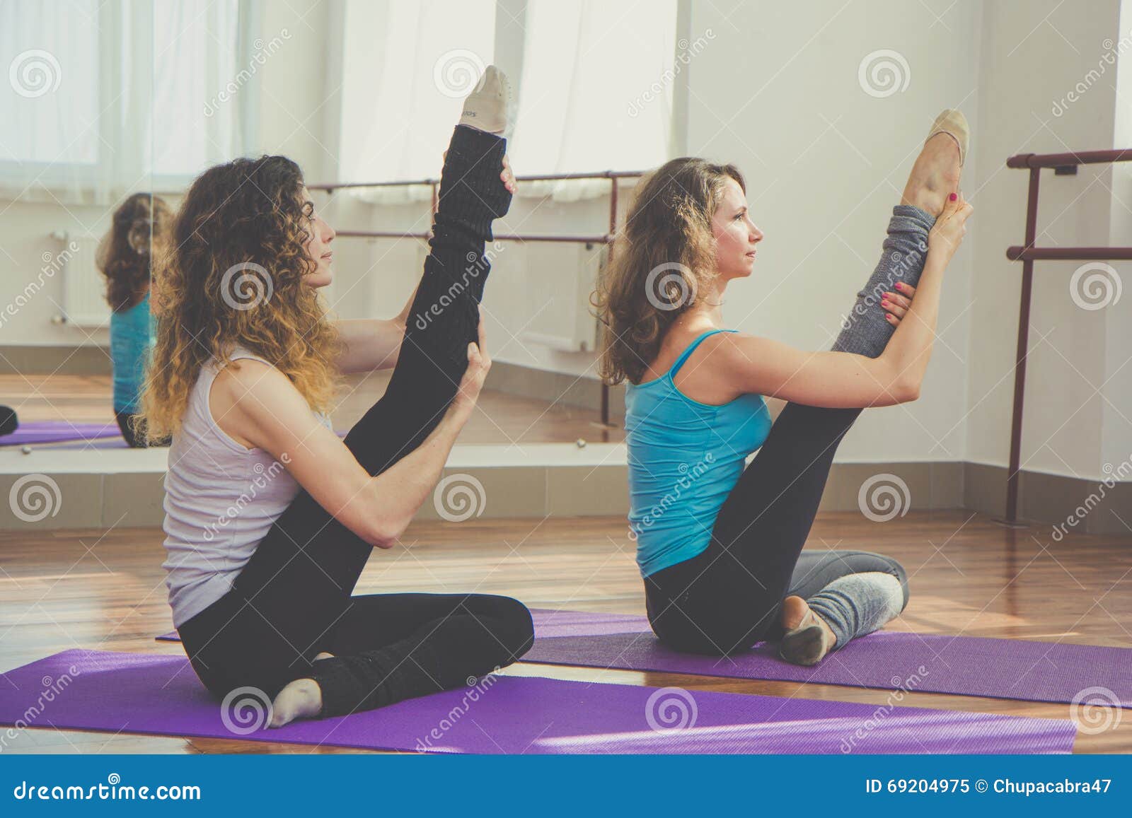 Two Fit Pretty Women are Stretching Legs Together Stock Image - Image ...