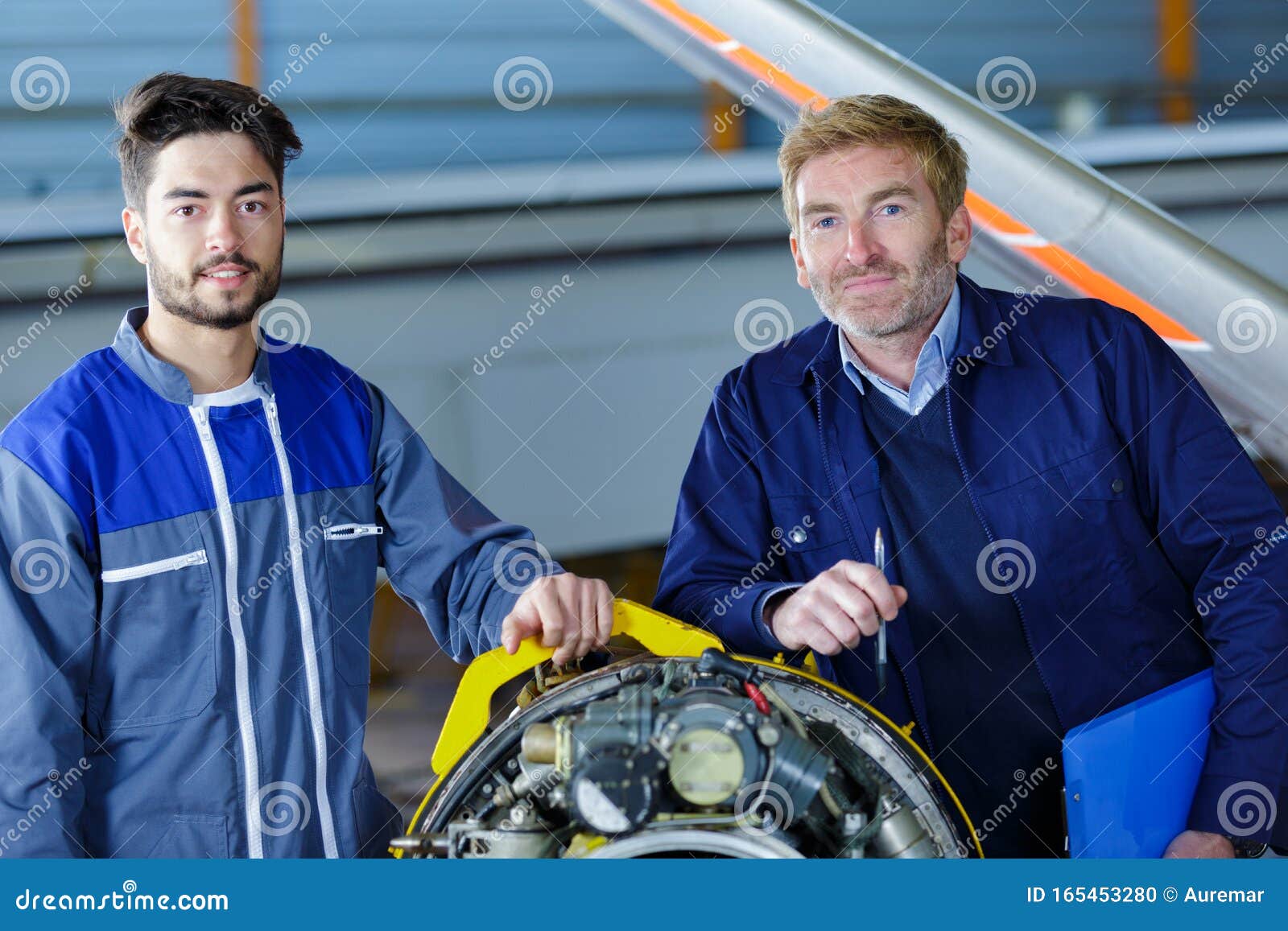 Two Flight Engineers Posing in Large Aircraft Hangar Stock Photo ...