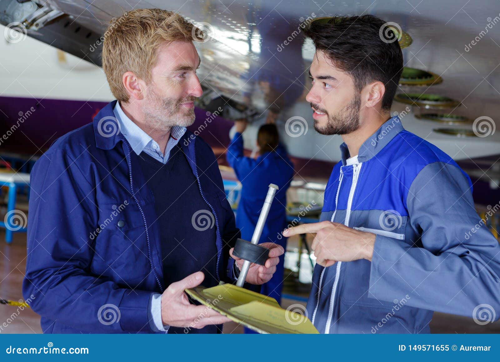 Two Flight Engineers Talking in Large Aircraft Hangar Stock Image ...