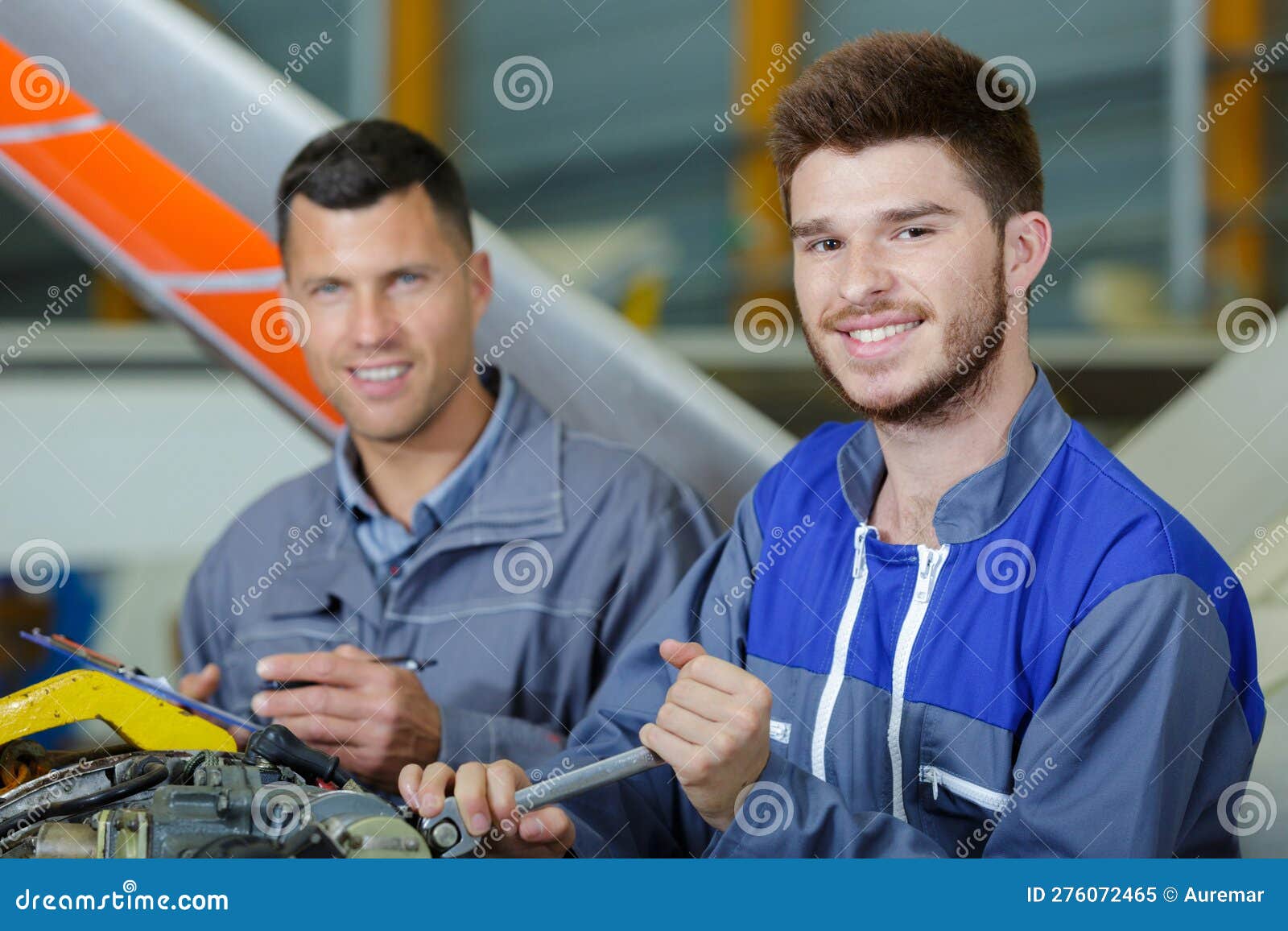 Two Flight Engineers Working in Aircraft Hangar Stock Image - Image of ...