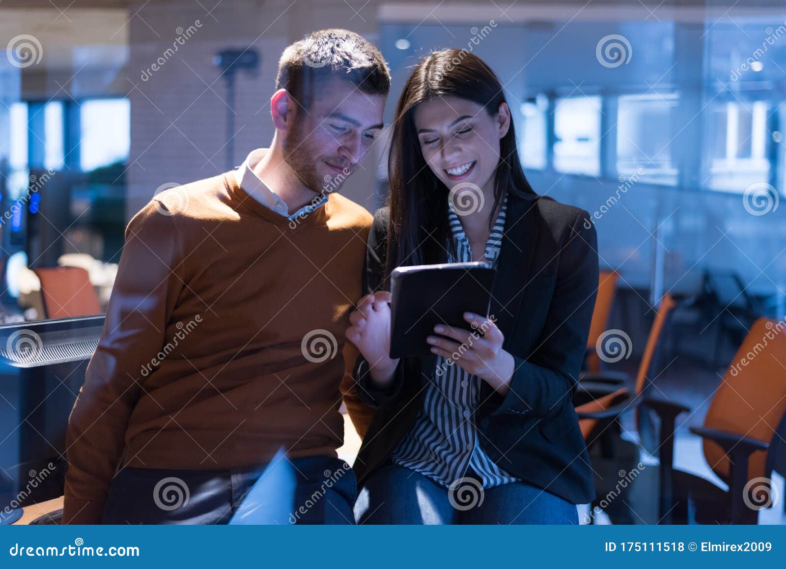 Two Focused Young Business Colleagues Talking Over a Digital Tablet ... Two Focused Young Business Colleagues Talking Over a Digital Tablet ...