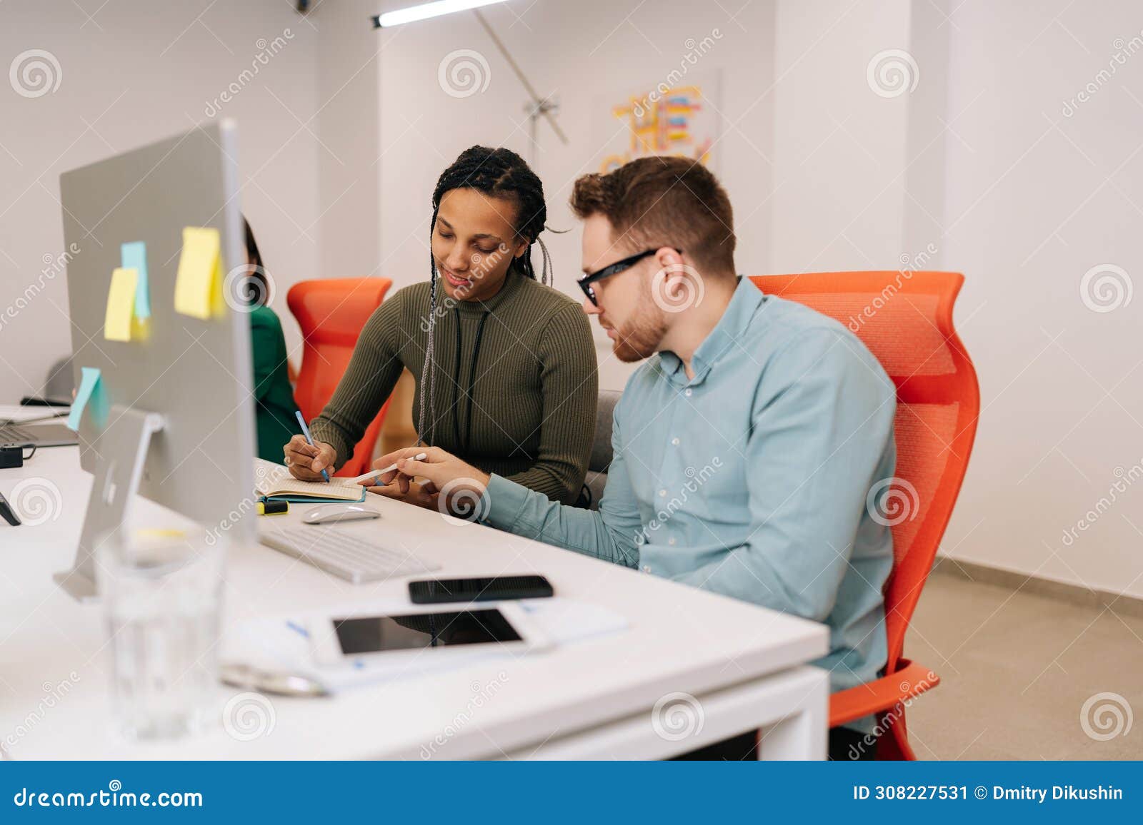 Two Focused Young Diverse Business People Analysts Partners Talking, Working Together ...
