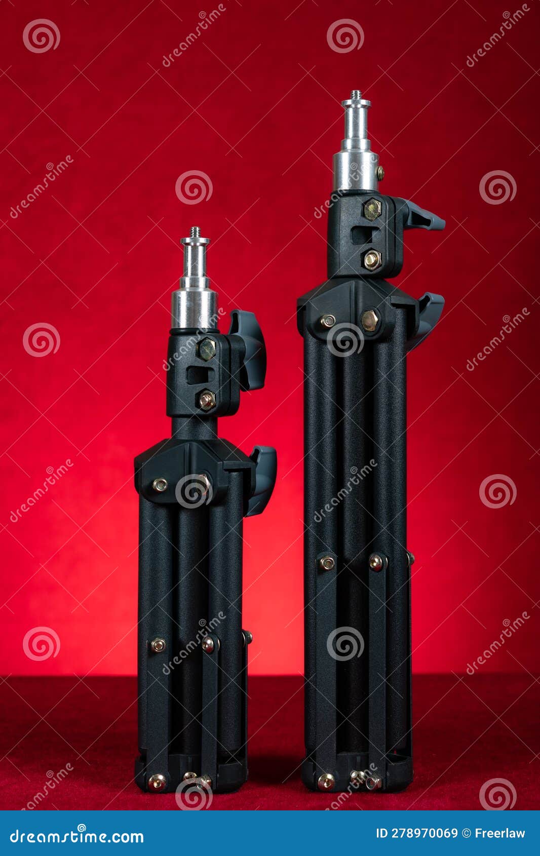 Folded Light Stands for Photography on Red Background at Vertical ...