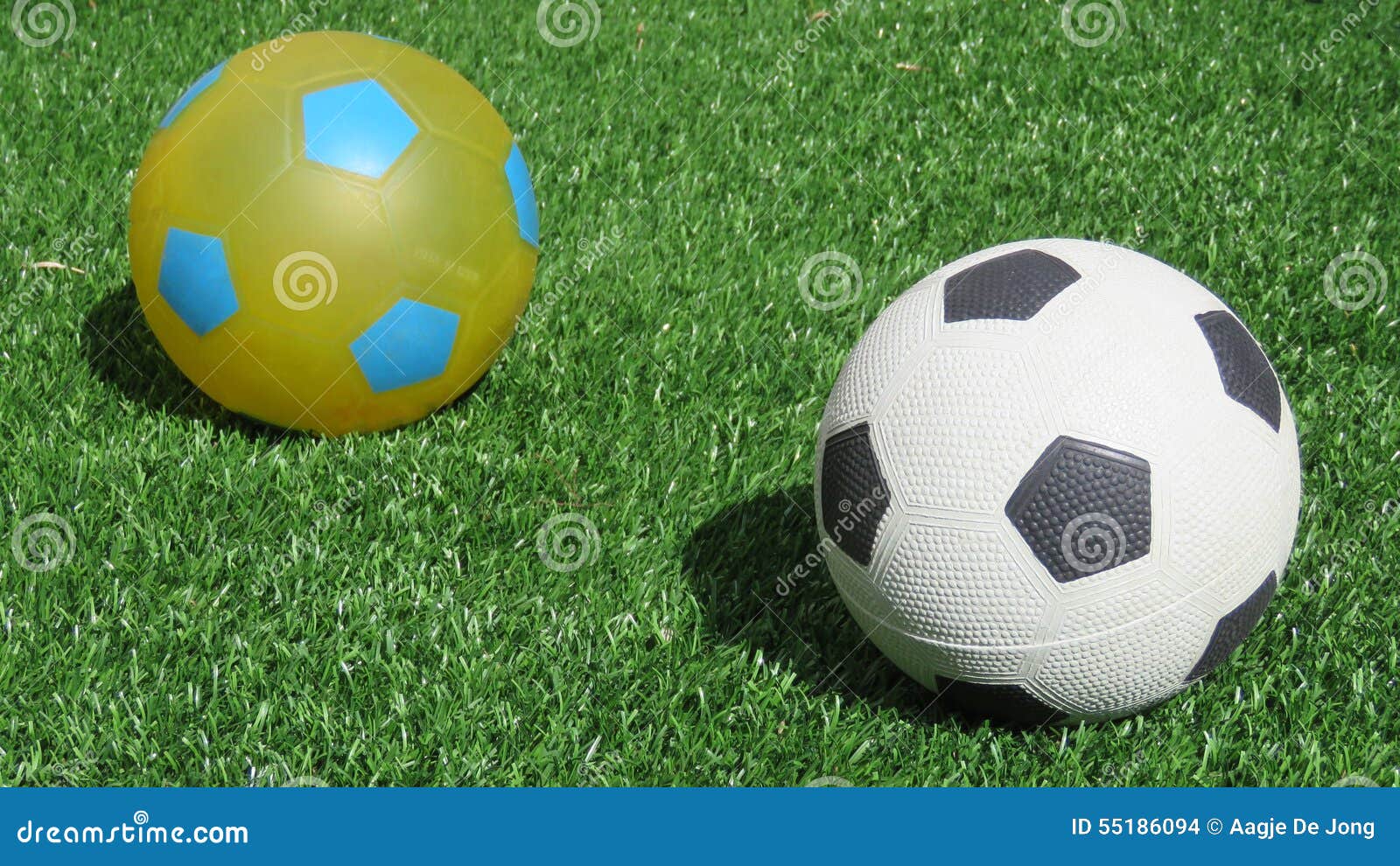 Two footballs on grass stock photo. Image of sport, small - 55186094