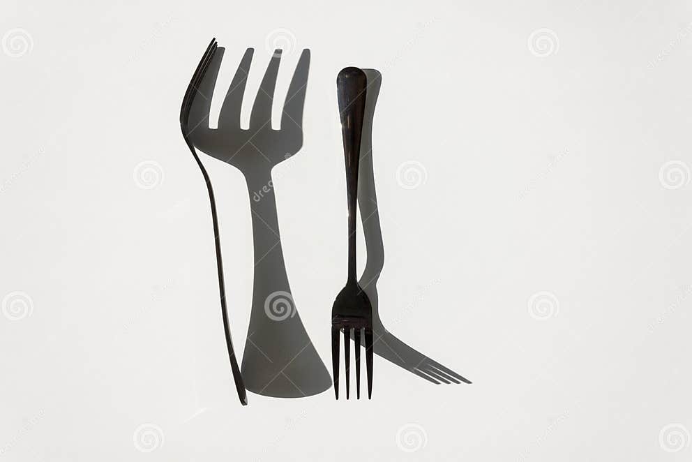 Two Forks with Sharp Shadows of Sun on a White Background. Menu Design ...