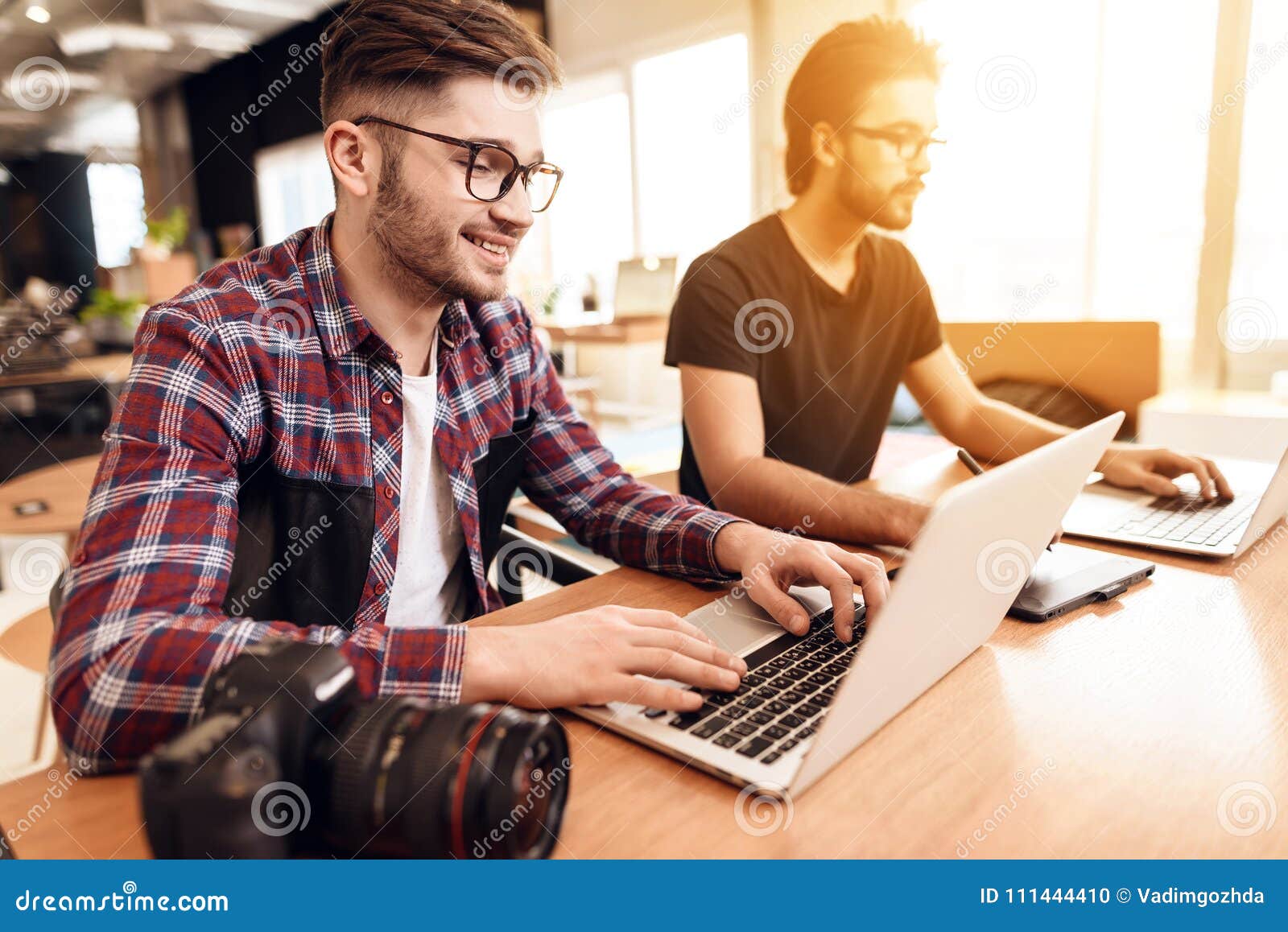 Two Freelancer Men Working at Different Laptops at Desk. Stock Photo ...