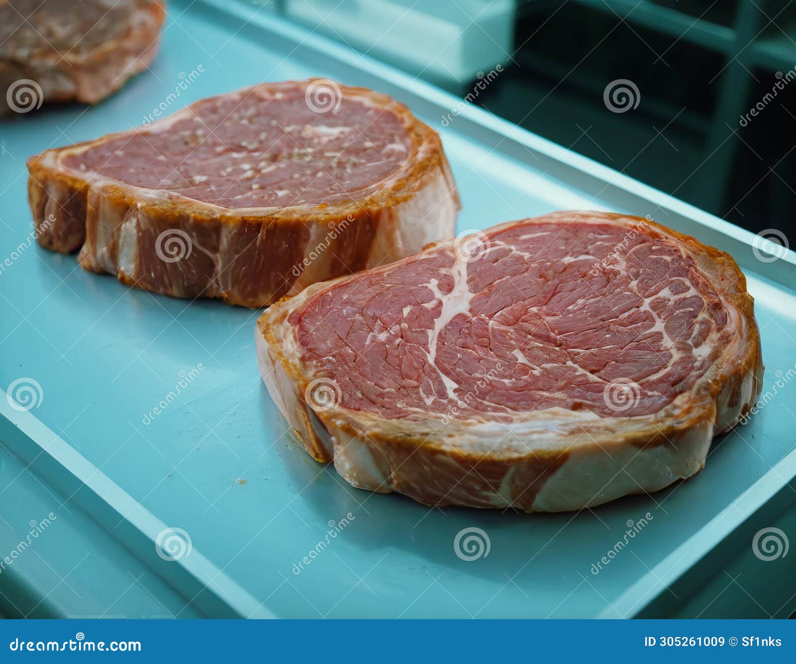 Two Fresh Raw Steaks on a Blue Tray, Ready for Cooking. Stock Image ...